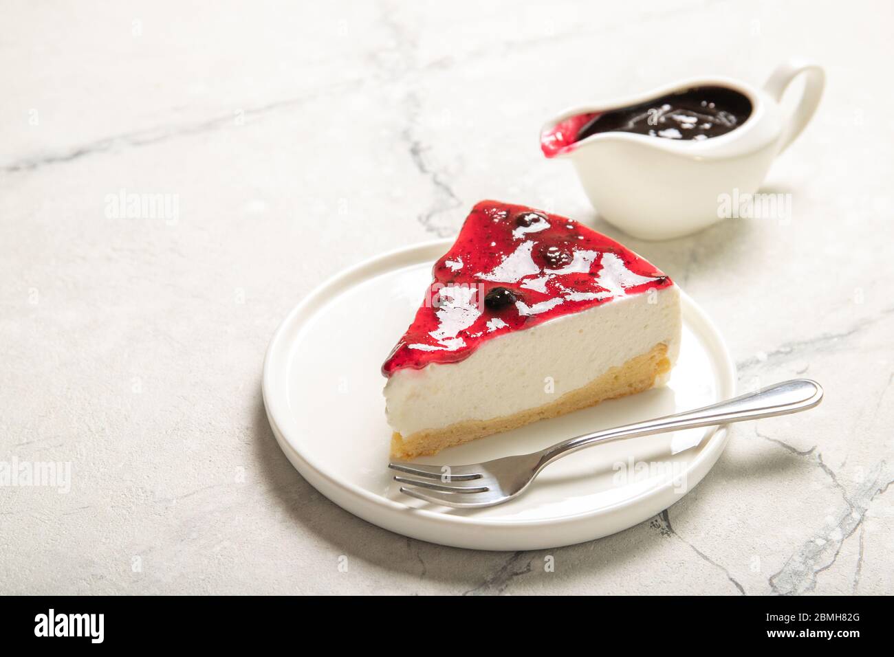 Cheesecake with jam on the table Stock Photo - Alamy