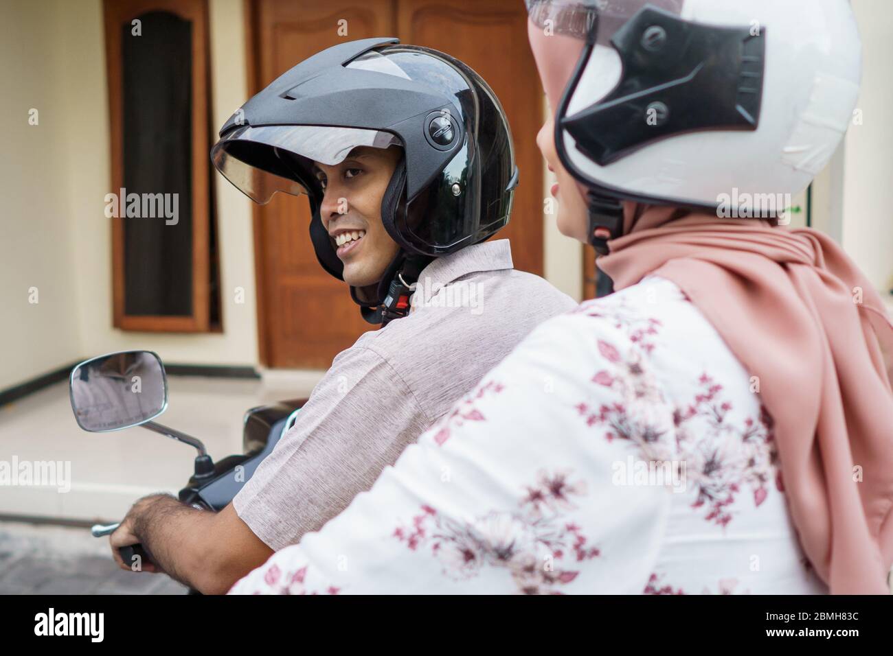 muslim woman and man riding motorcycle together Stock Photo - Alamy