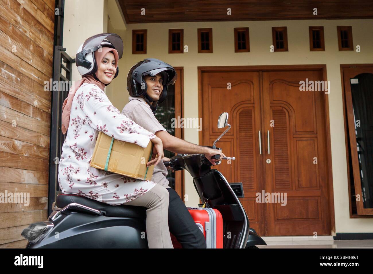 Muslim couple riding a motorcycle for travel in eid mubarak Stock Photo ...