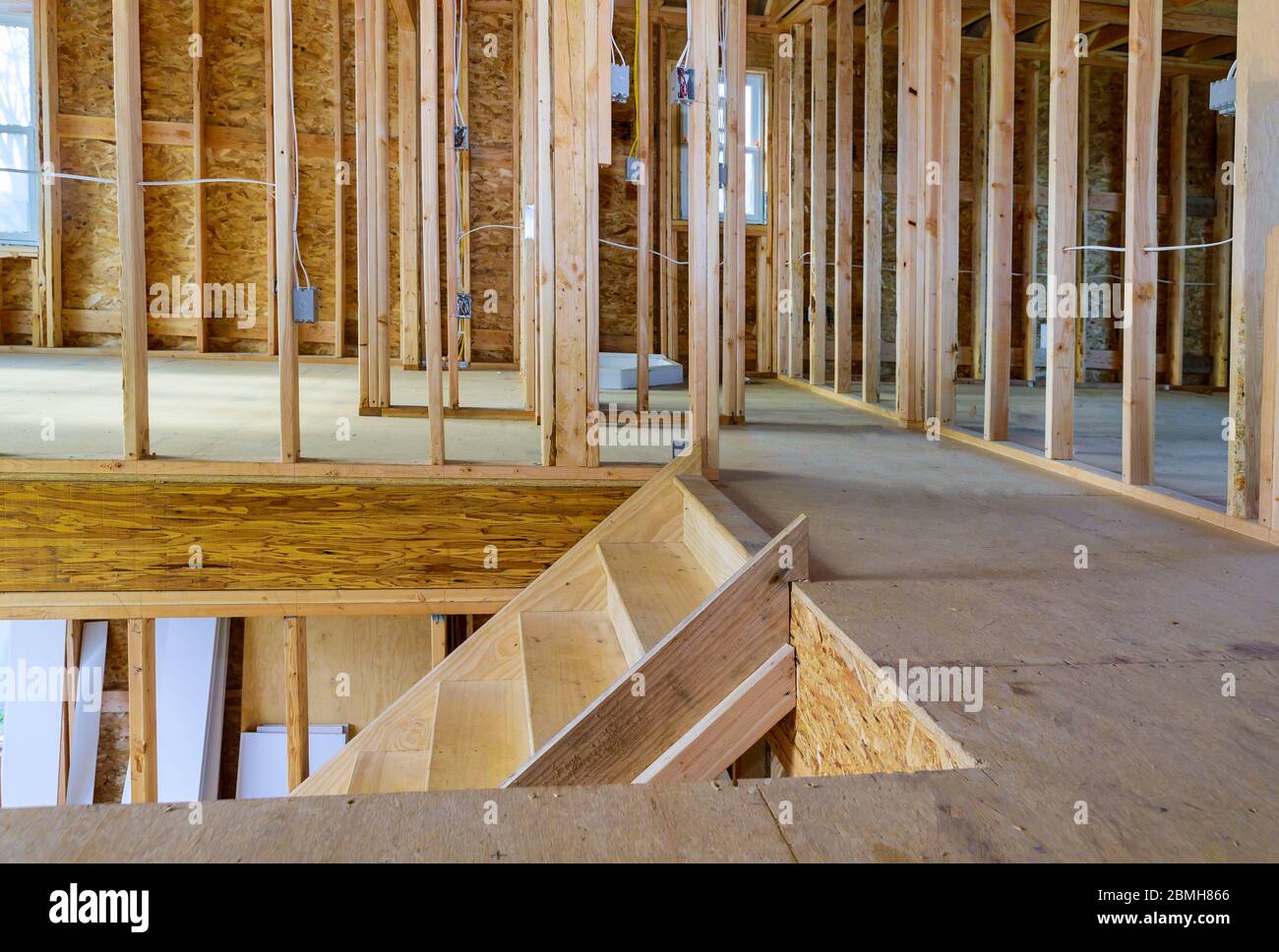 New home under construction on of framing of beams house Stock Photo ...