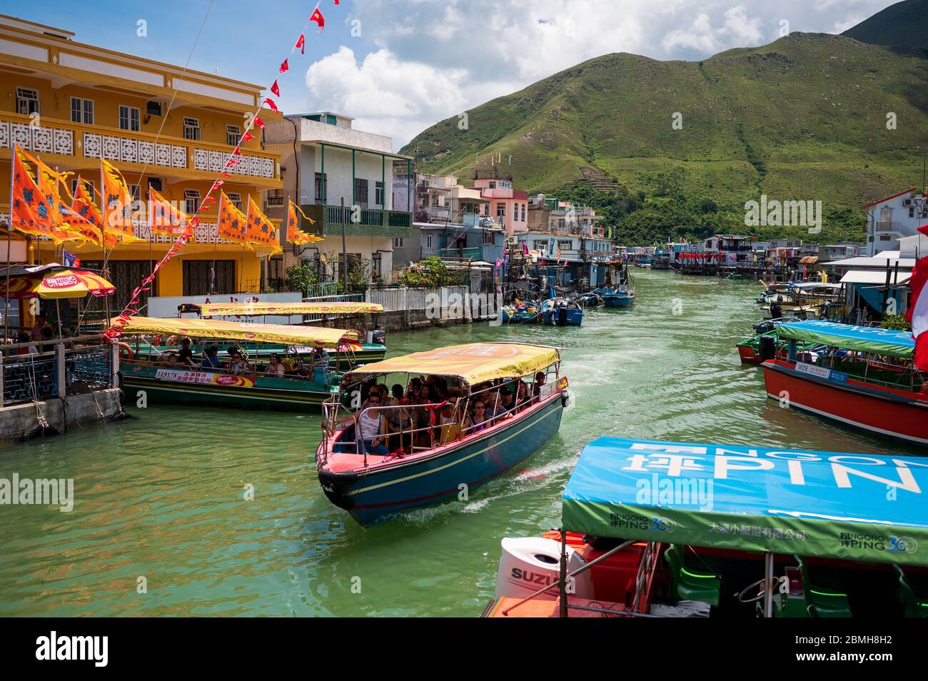 Boats in Tai O fishing village which is a popular tourist destination ...