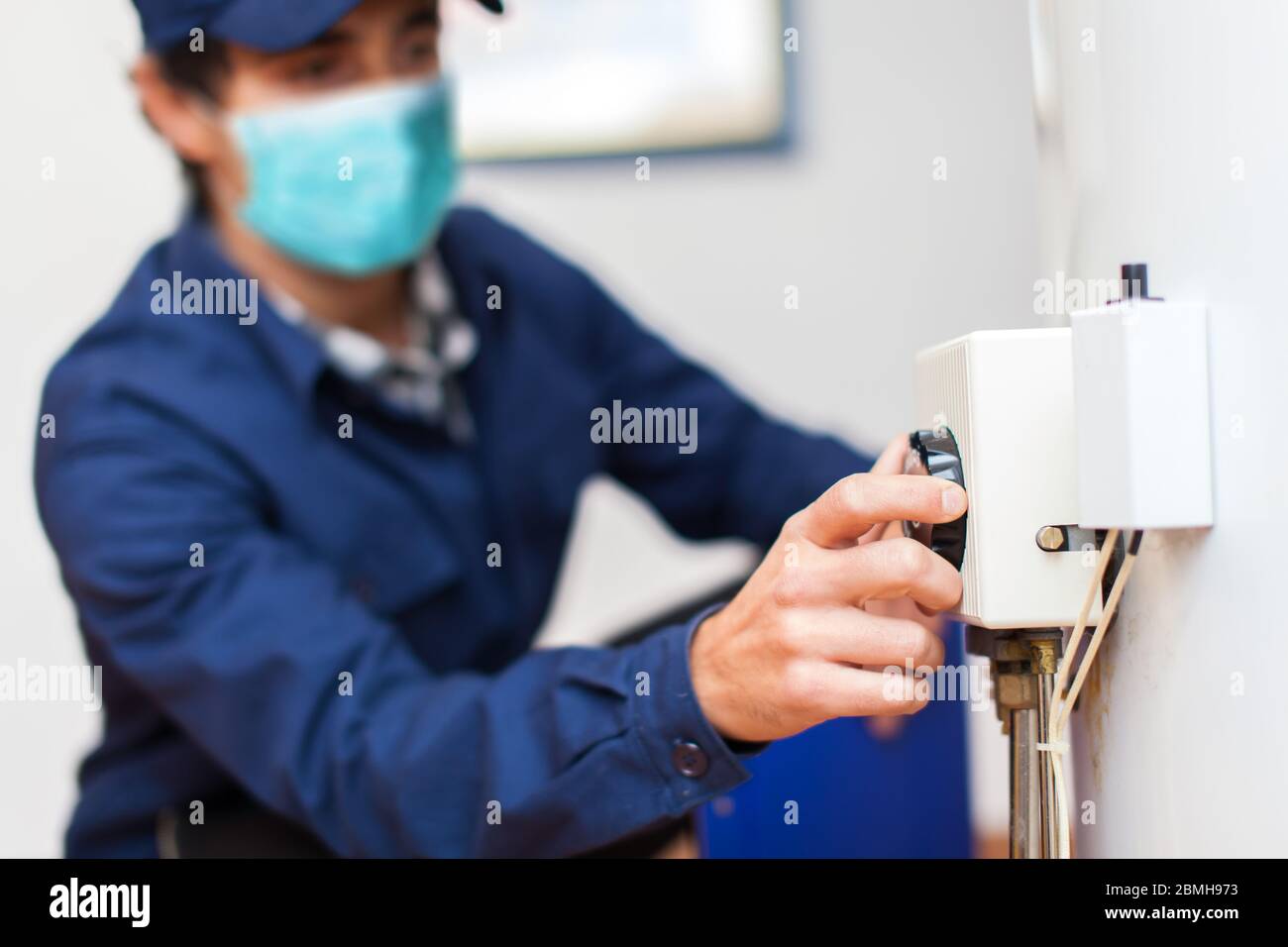 Portrait of an electrician at work wearing a mask, coronavirus concept ...