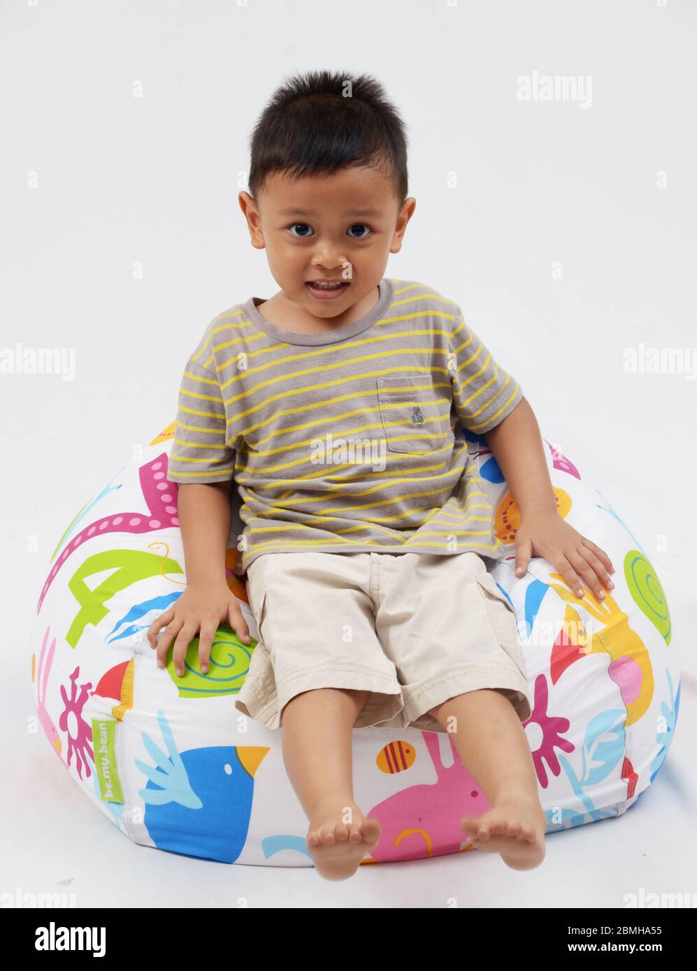 kid sit on th chair bean back Stock Photo - Alamy