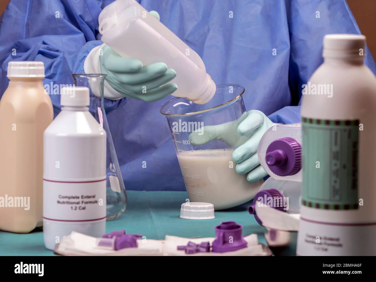 Nurse filling bottle supply in team of enteral nutrition, palliative ...