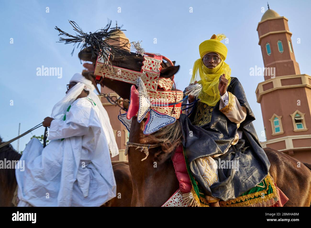Nobleman rider dressed in a colourful outfit mounting an embellished ...