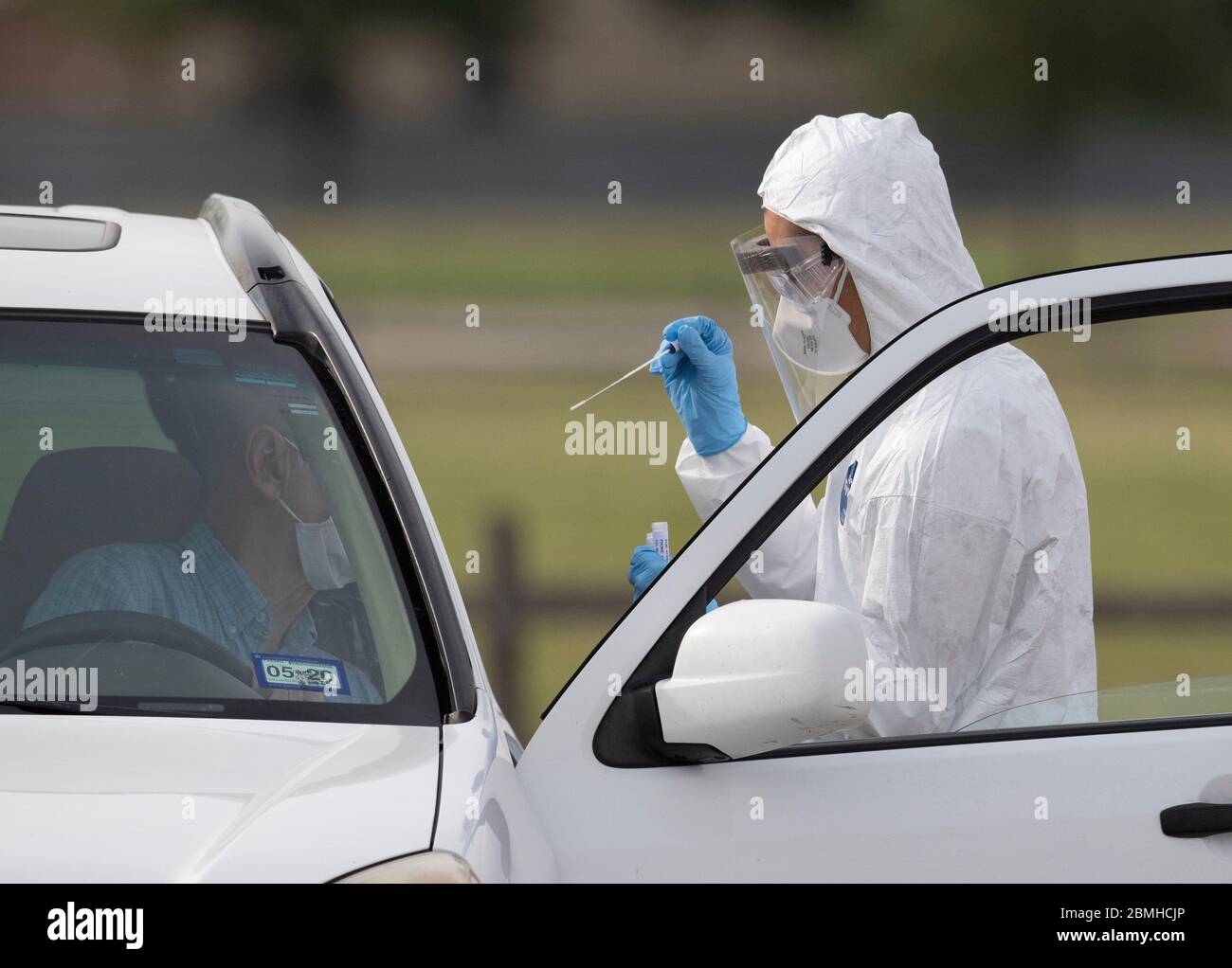 PFC Joshua Ramon takes a nasal swab sample as the Texas National Guard ...