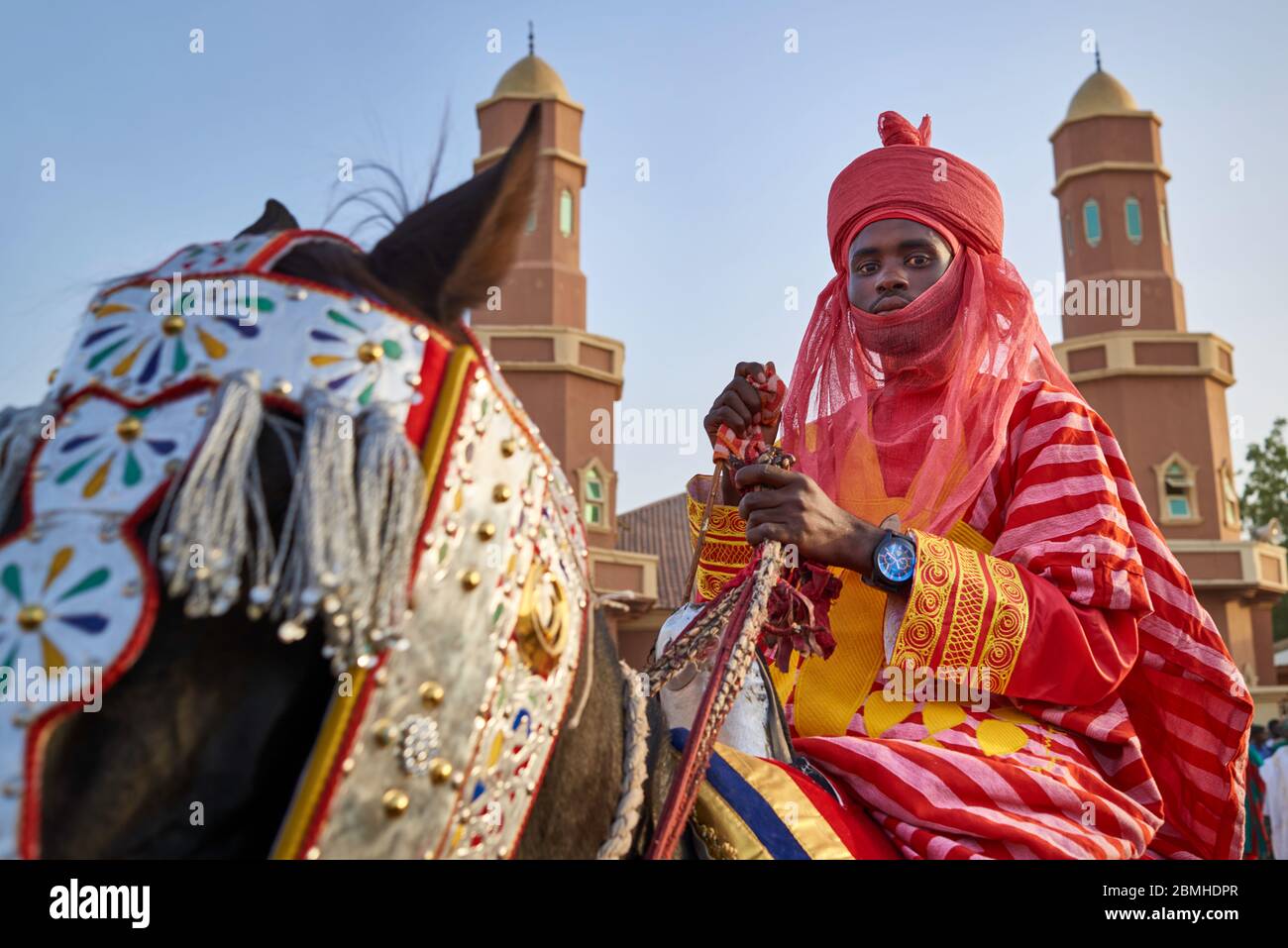 Nobleman rider dressed in a colourful outfit mounting an embellished ...