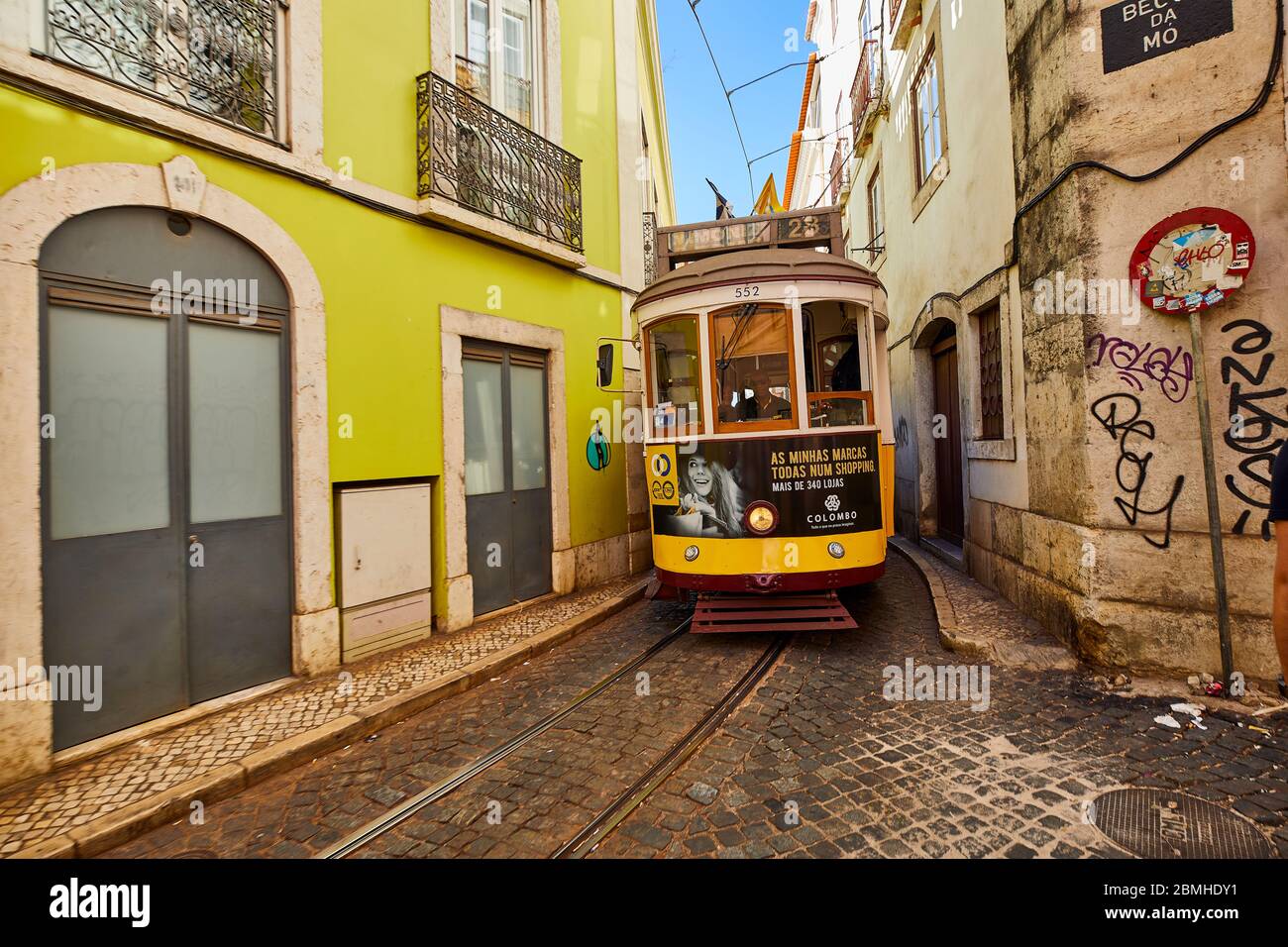 A trolley moves through the Alfama neighborhood of Lisbon, Portugal ...