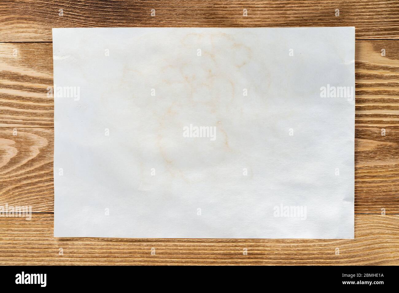 Flat lay wooden table with paper sheet Stock Photo - Alamy
