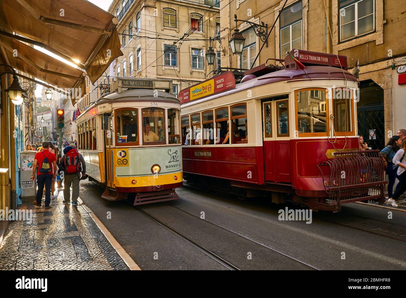 A trolley moves along a street in the Old Town area of Lisbon, Portugal ...