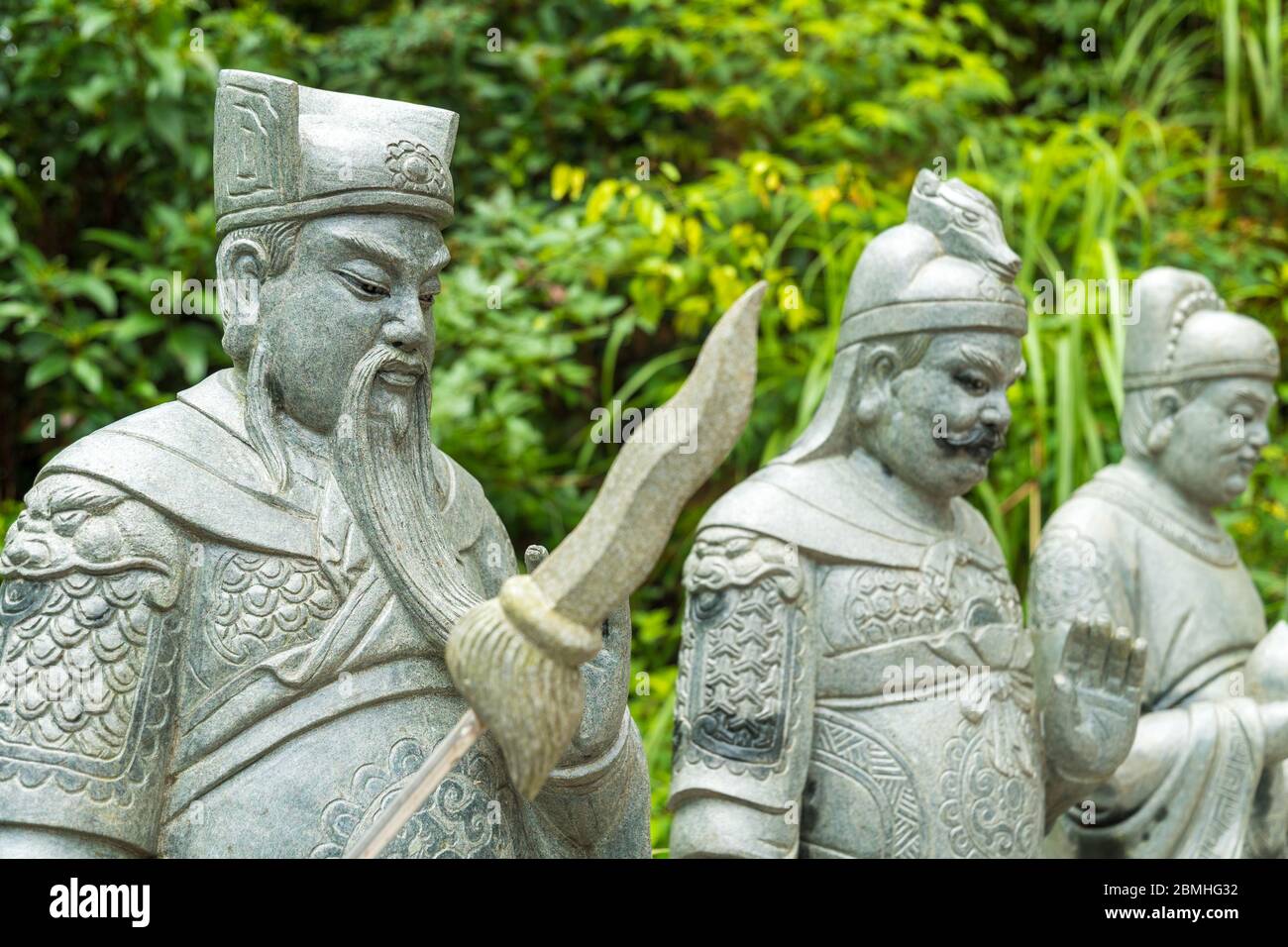 Standing stone statue with weapon at the buddhist Temple of Ten ...