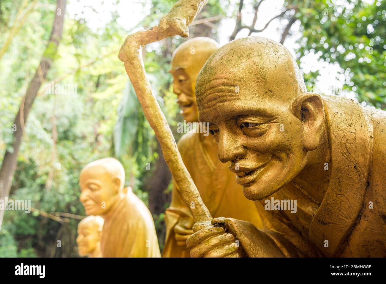 Seated gold-coloured statues at the buddhist Temple of Ten Thousand ...