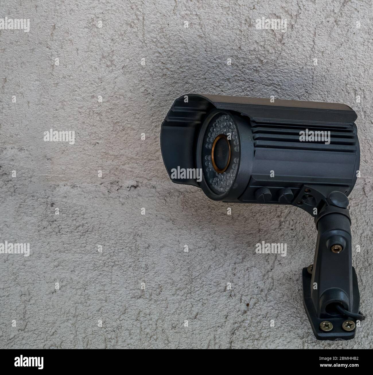 Close up with a security surveillance camera. CCTV camera on a wall ...