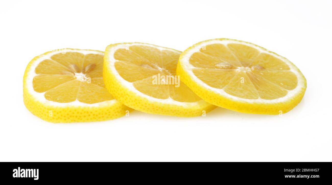 Sliced lemon round slices, white background, macro Stock Photo - Alamy