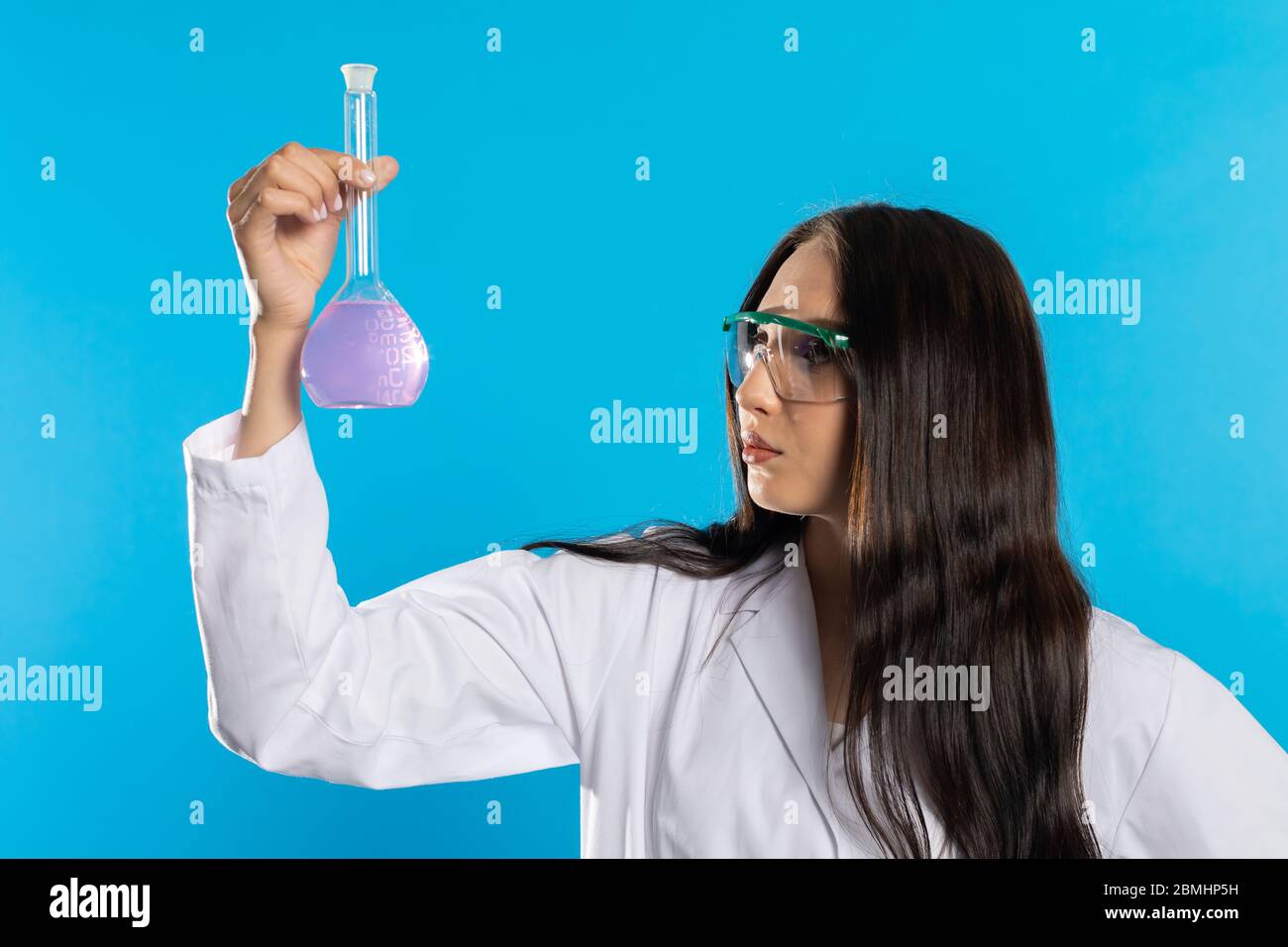 In the glass laboratory vial there is the beginning of a medicine for ...