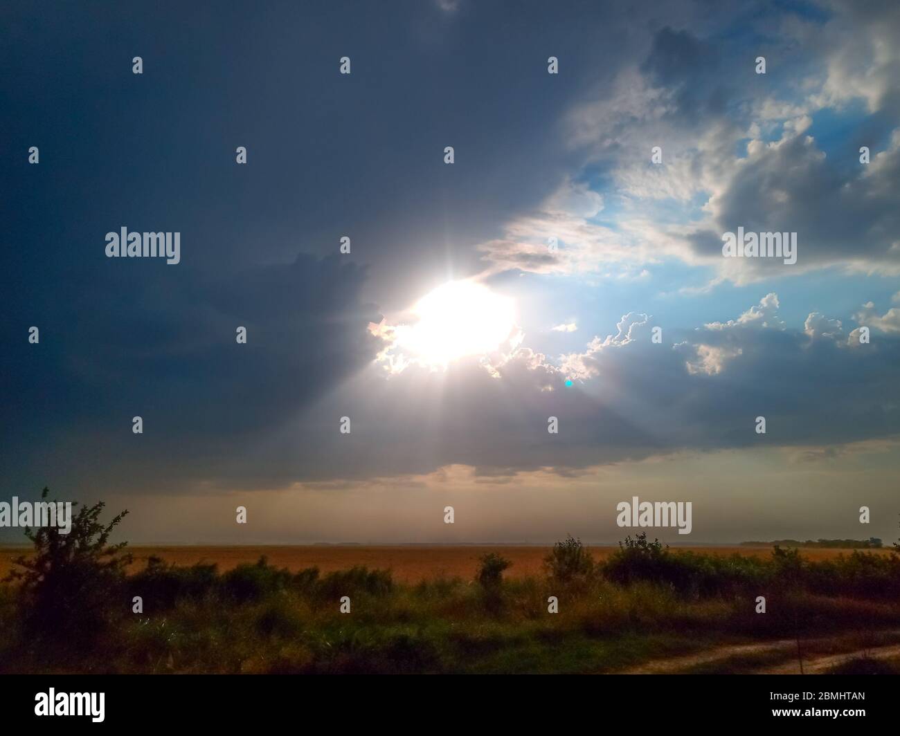 Beautiful sunset, sun rays through the clouds Stock Photo - Alamy
