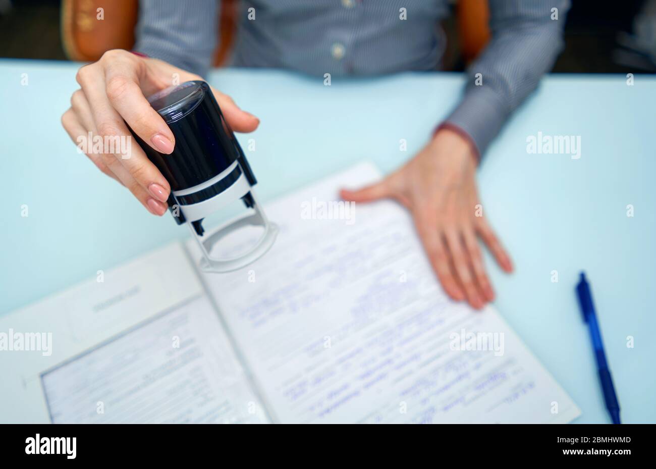 little girl puts a stamp on documents Stock Photo - Alamy
