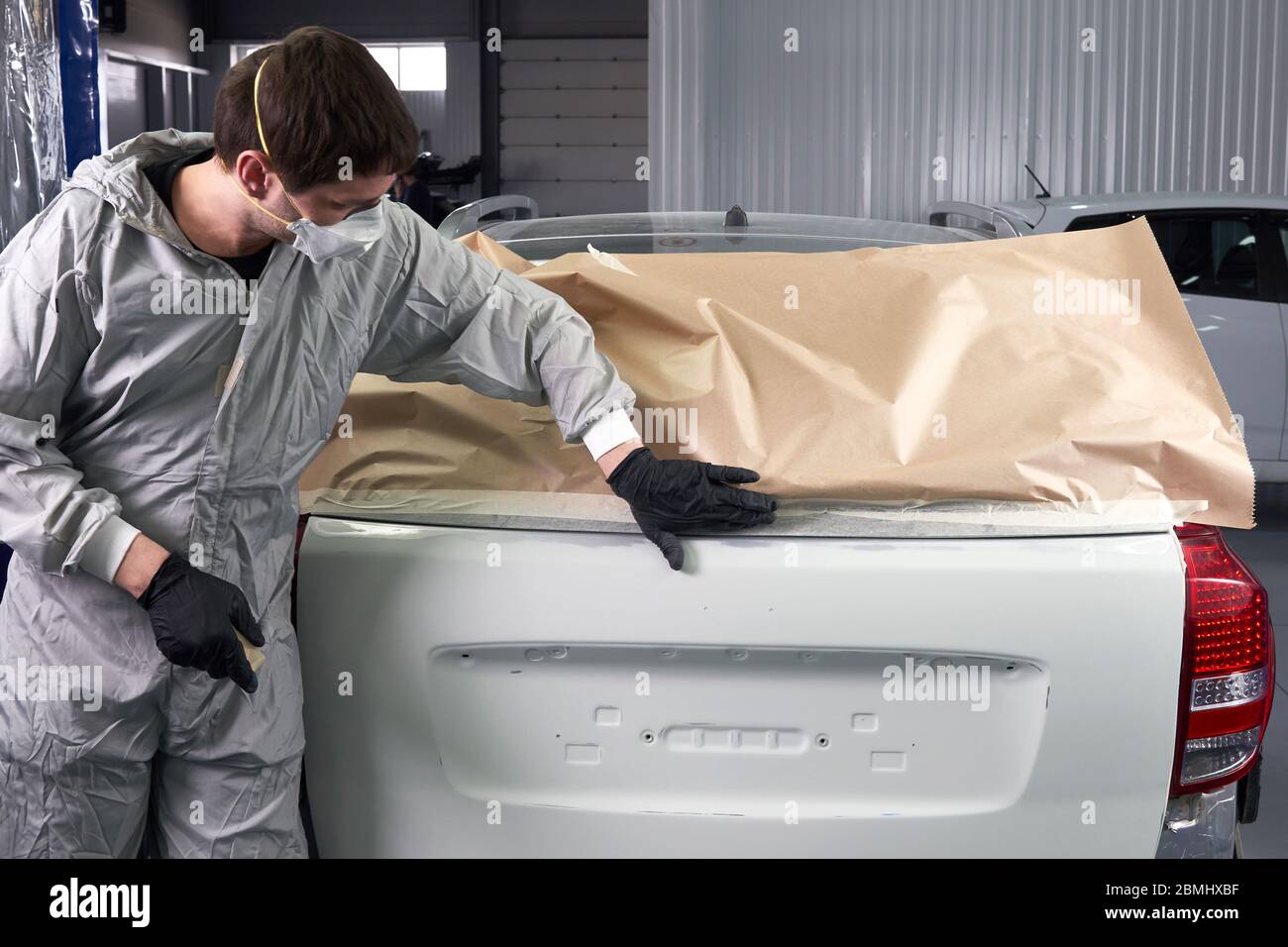 Mechanic covering car paper hi-res stock photography and images - Alamy