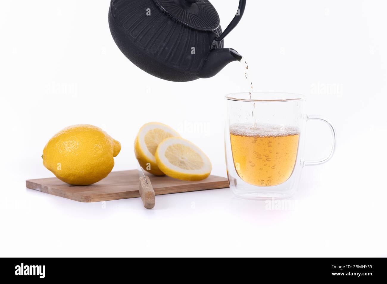 teapot pouring green tea in a transparent cup Stock Photo - Alamy