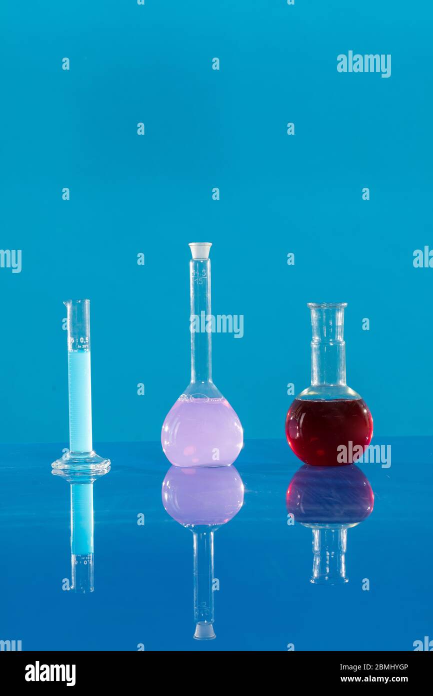 Colored chemicals in glass bottles are standing on a clean table Stock ...