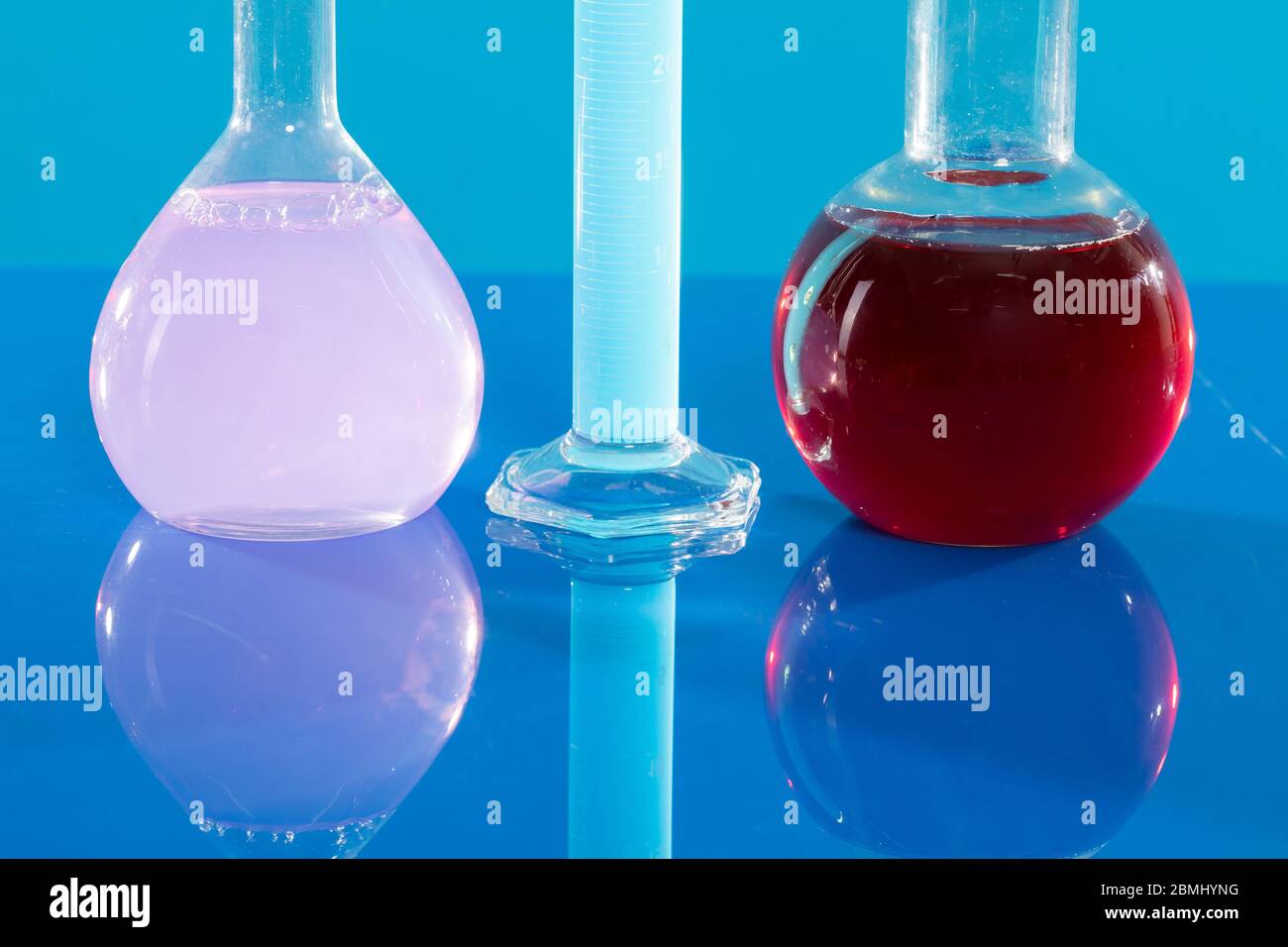 Colored chemicals in glass bottles are standing on a clean table Stock ...
