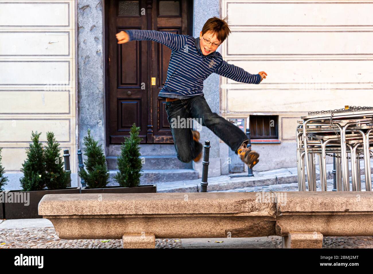 Young Boy jumping over a Bench Stock Photo - Alamy