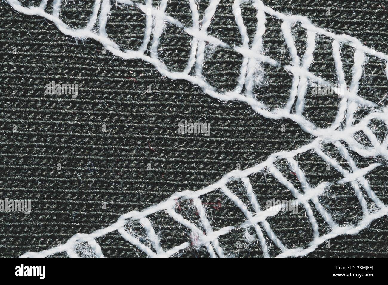 White seams on black fabric. stitches on textile material close up ...