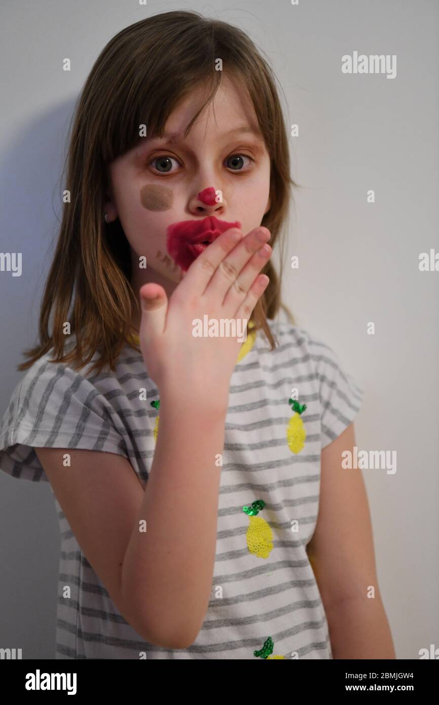 Cute little preschool girl playing with mommy's make up. Fashion ...