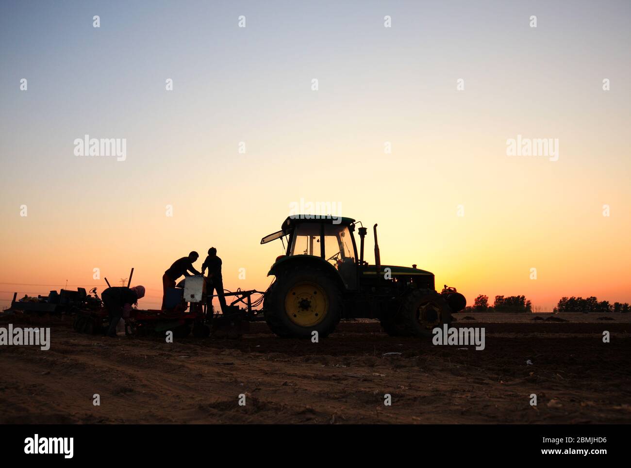 In the spring,The tractor in farmland farming Stock Photo - Alamy