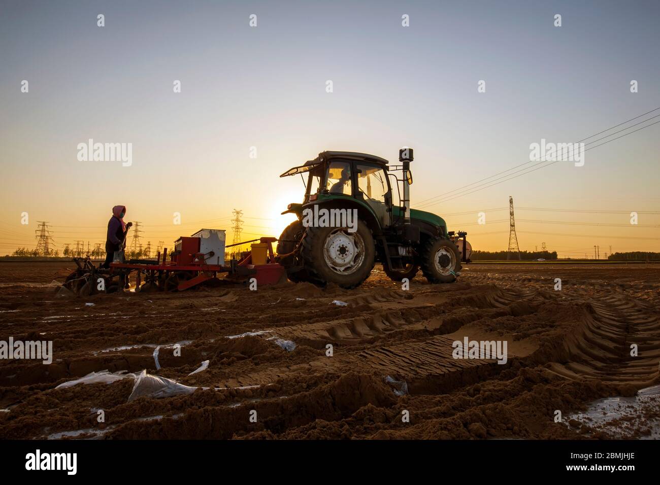 In the spring,The tractor in farmland farming Stock Photo - Alamy