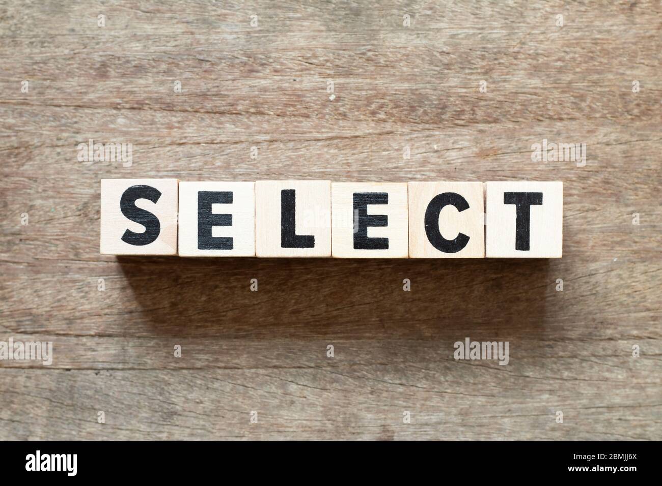Letter block in word select on wood background Stock Photo - Alamy