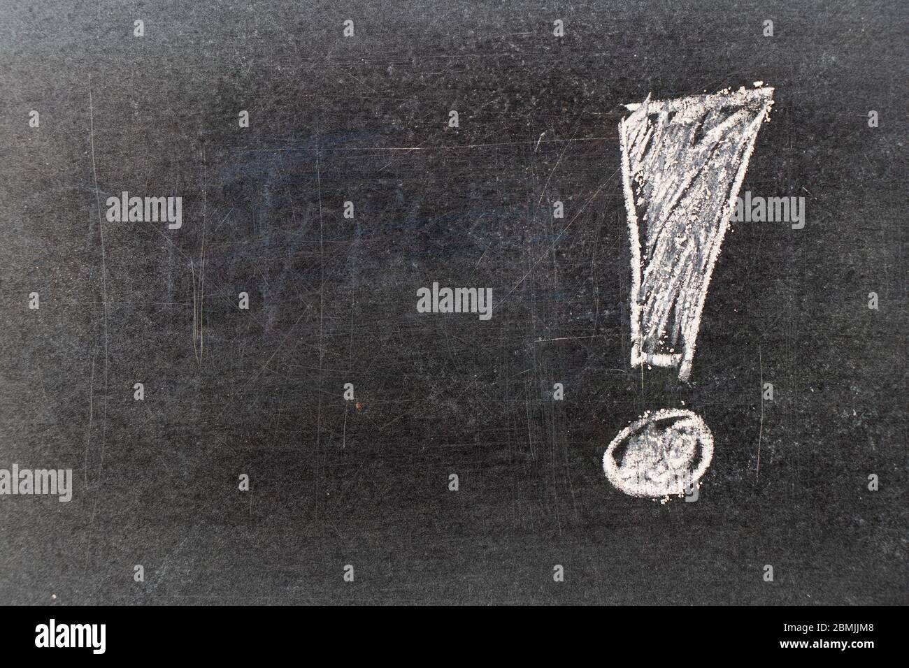 White color chalk hand drawing in exclamation mark with blank space ...