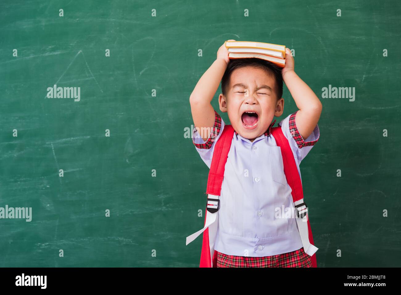 Back to School. Happy Asian funny cute little child boy from ...