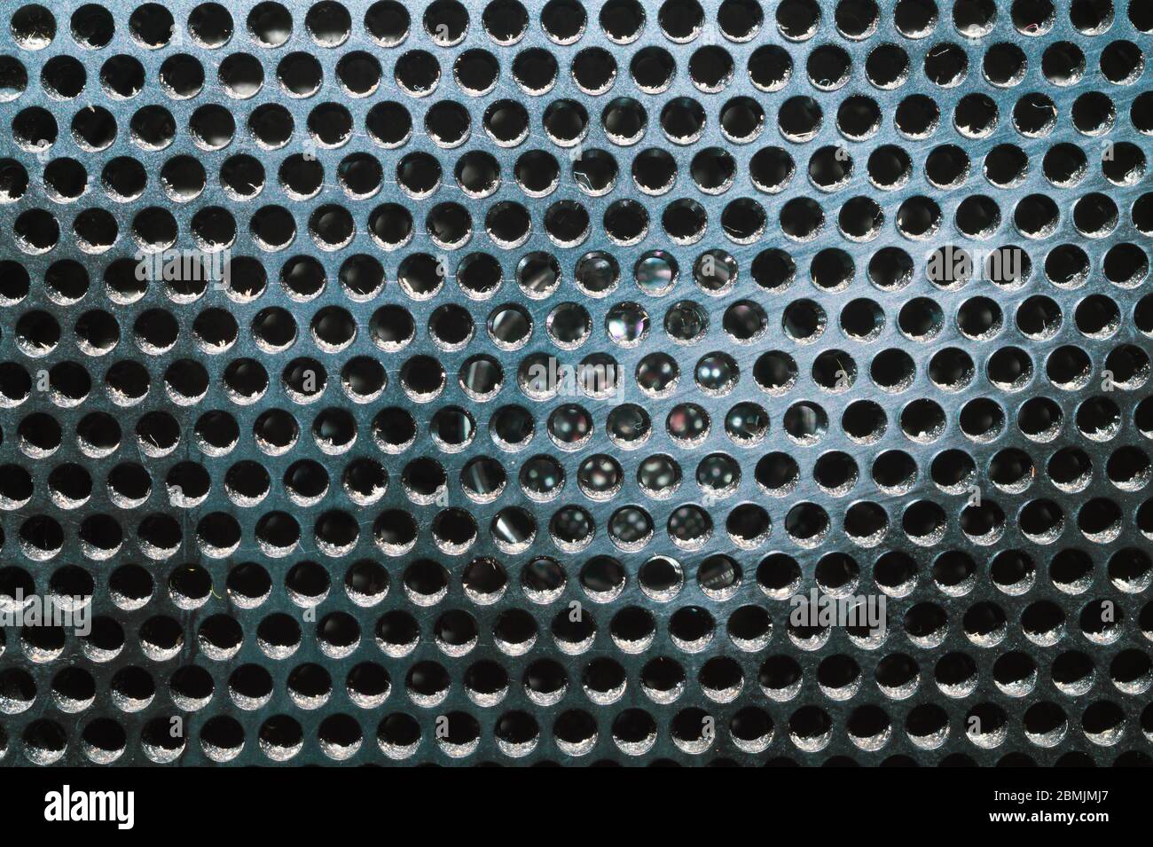 Grid pattern surface. dusty speaker mesh texture close up. perforated ...