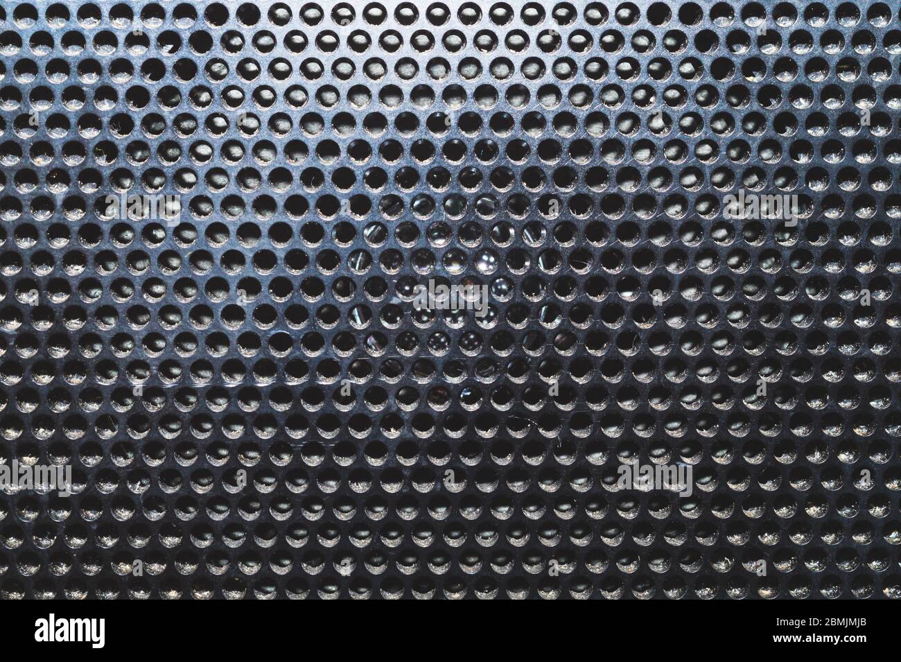 Grid pattern surface. dusty speaker mesh texture close up. perforated ...