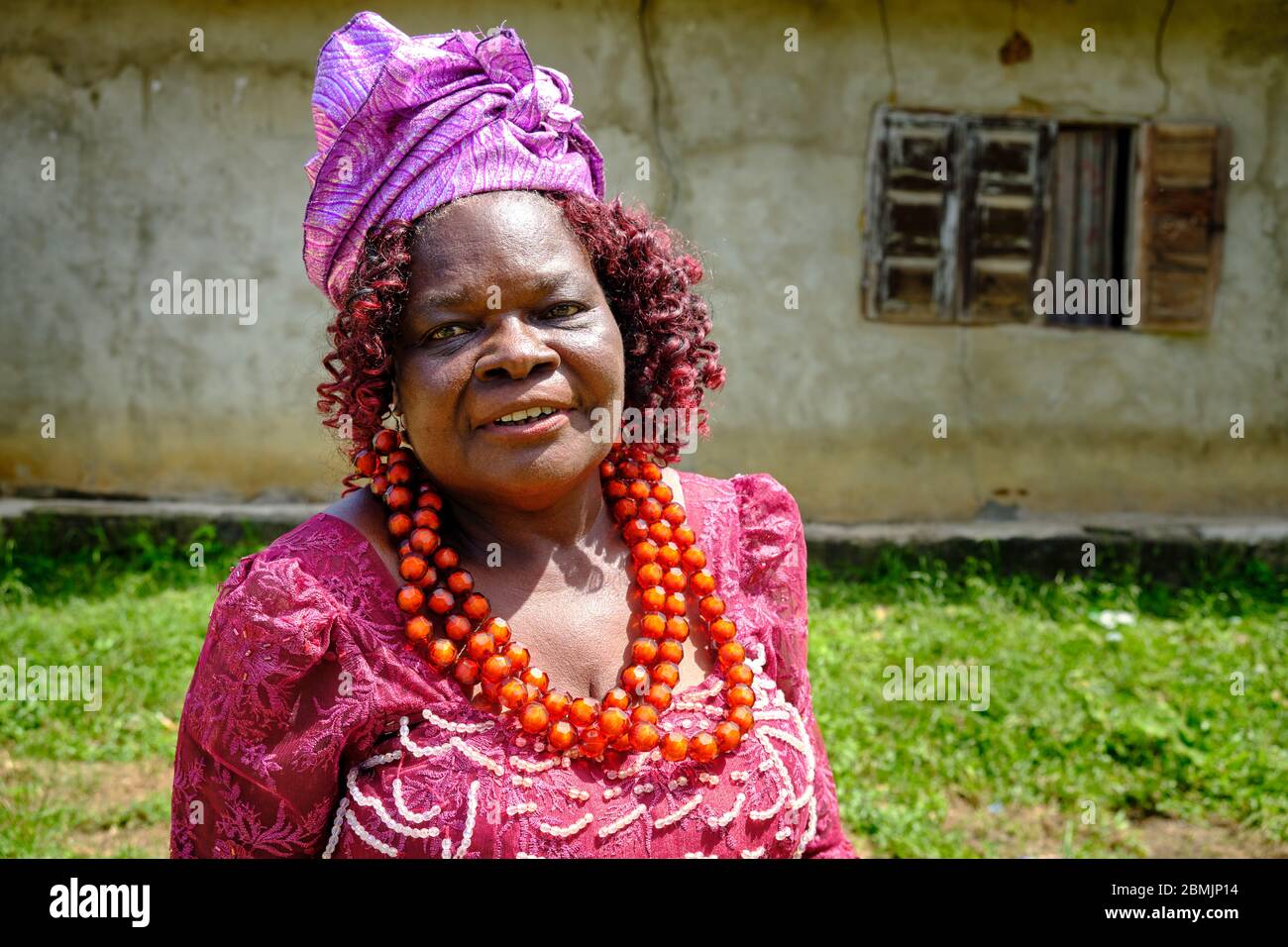 Efik woman in traditional dress and jewelry on her way to a council ...