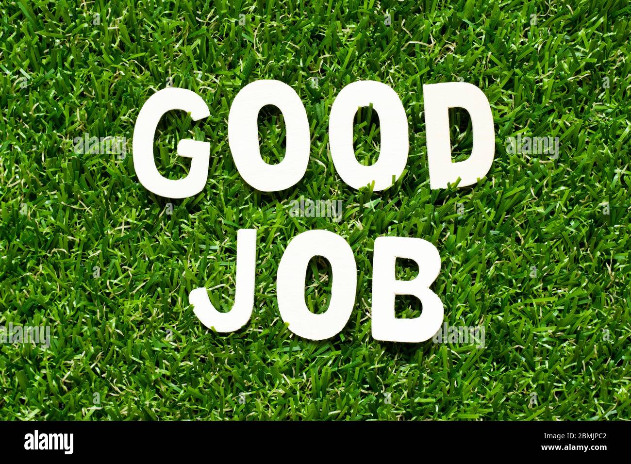 Wood alphabet letter in word good job on green grass background Stock ...