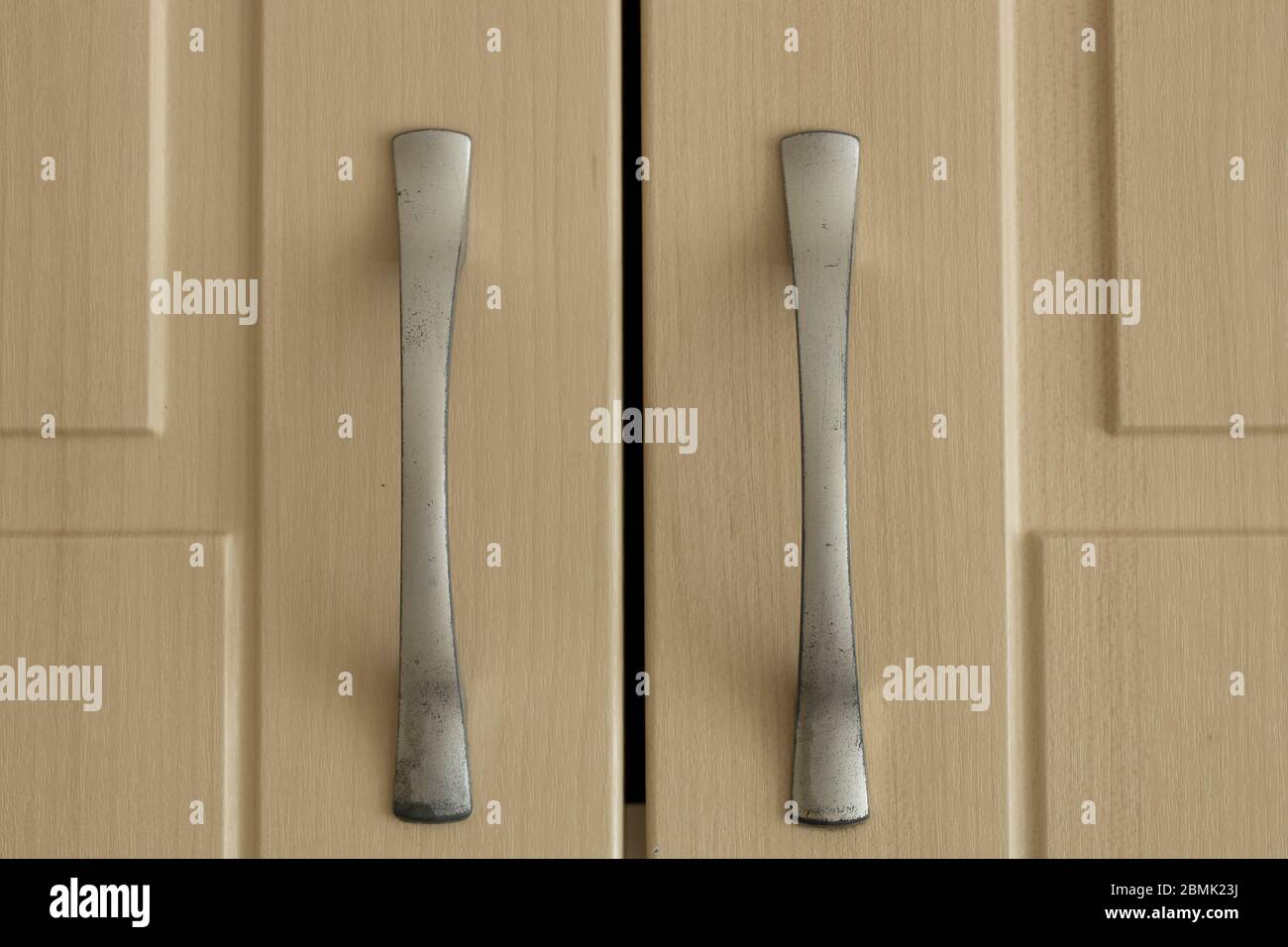 Cabinet handles close-up. Cabinet color is white and handle color is ...