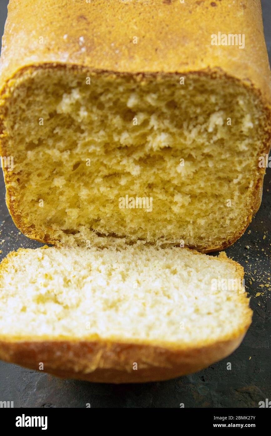Fresh fragrant bread against a dark background. Assortment of baked ...