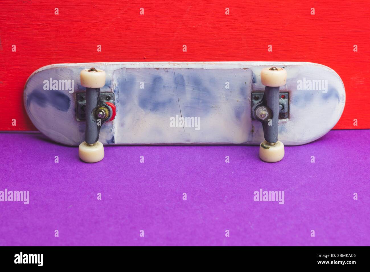 Small skateboard on color background. tiny skate for fingers ...