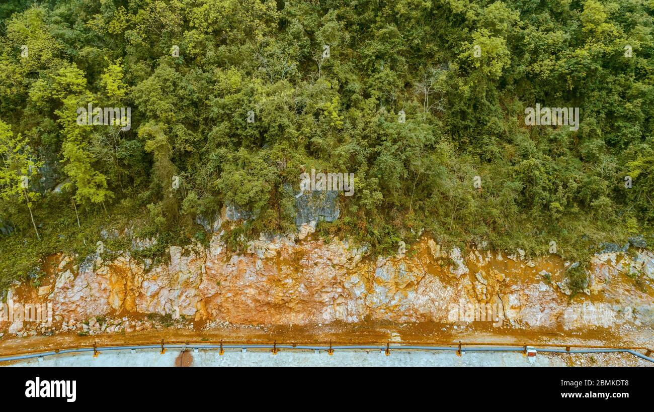 Aerial View of concrete wall and rubble road beside a tailing ponds ...