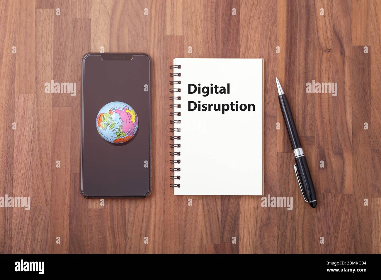 Digital disruption concept with world on smartphone on office desk, top ...