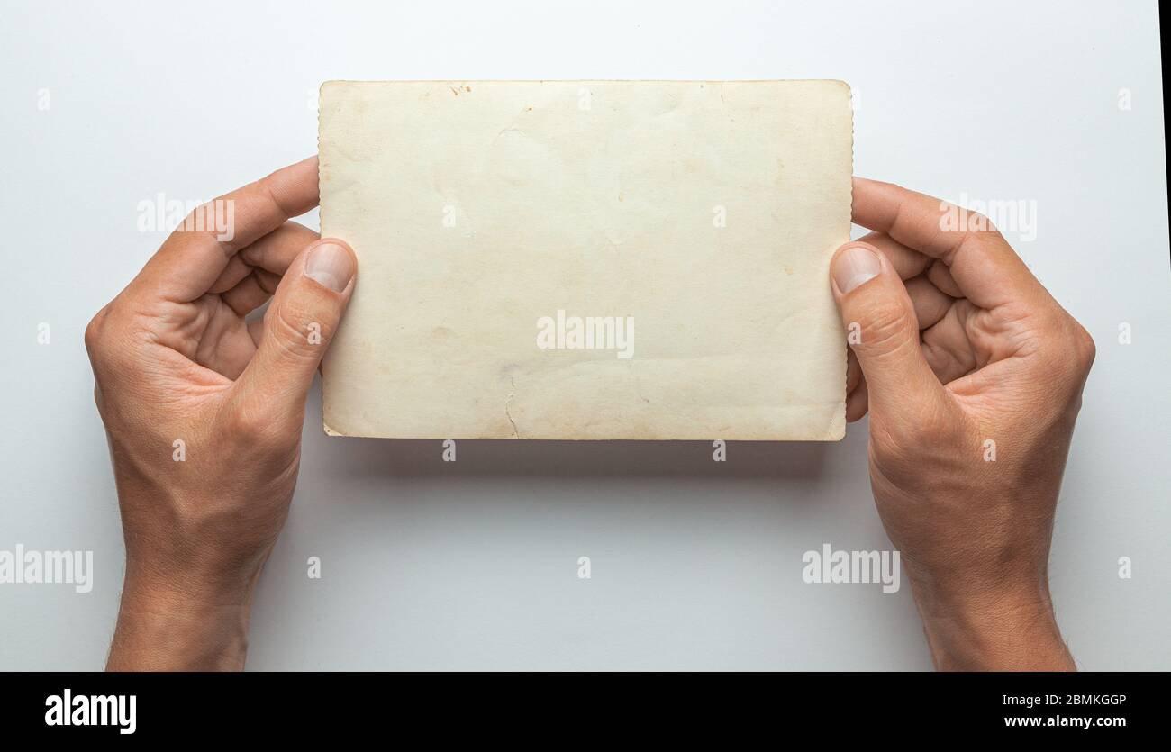 Old photo in the hands of man. Empty template for picture, mock-up ...