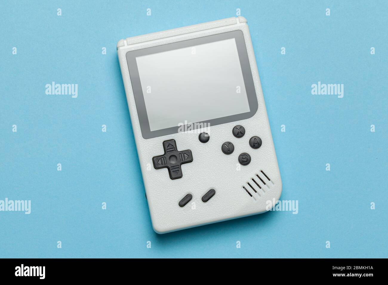 Old game console. Gamepad is white on blue background. Copy space for ...
