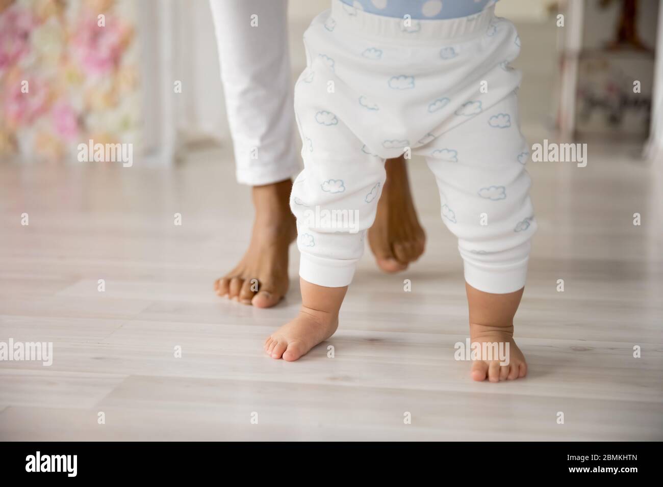 Close up of little baby make first steps with mom Stock Photo - Alamy