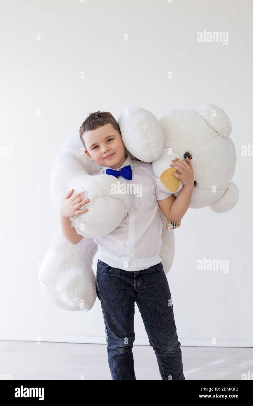Beautiful little boy with toy big teddy bear Stock Photo - Alamy