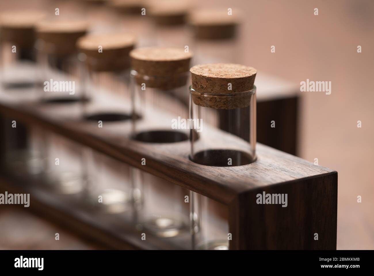 empty walnut holder with glass tubes for spices on walnut table surface ...