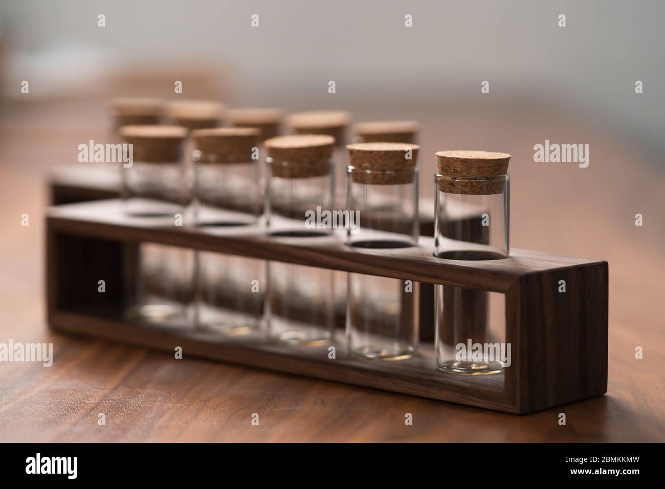 empty walnut holder with glass tubes for spices on walnut table surface ...
