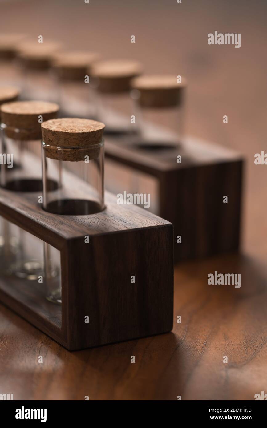 empty walnut holder with glass tubes for spices on walnut table surface ...