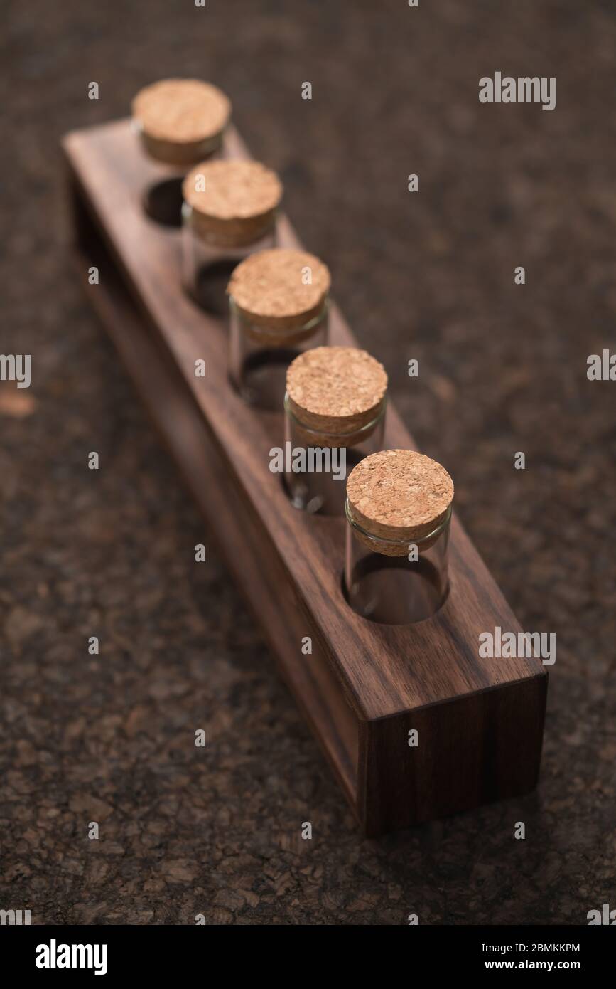 empty walnut holder with glass tubes for spices on cork surface Stock ...